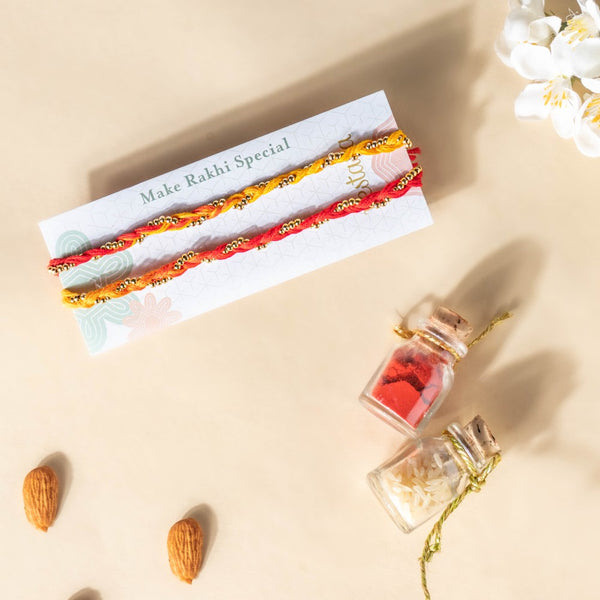 Beaded Thread Rakhi Set Of 2 With Rice Roli